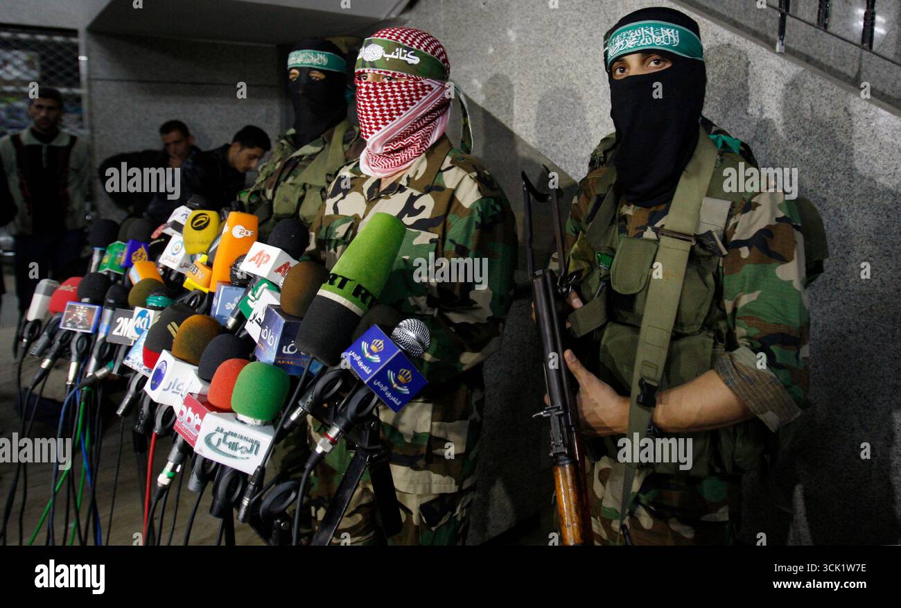 FILE - Abu Obeida, center, spokesman for the Qassam Brigades, the Hamas ...