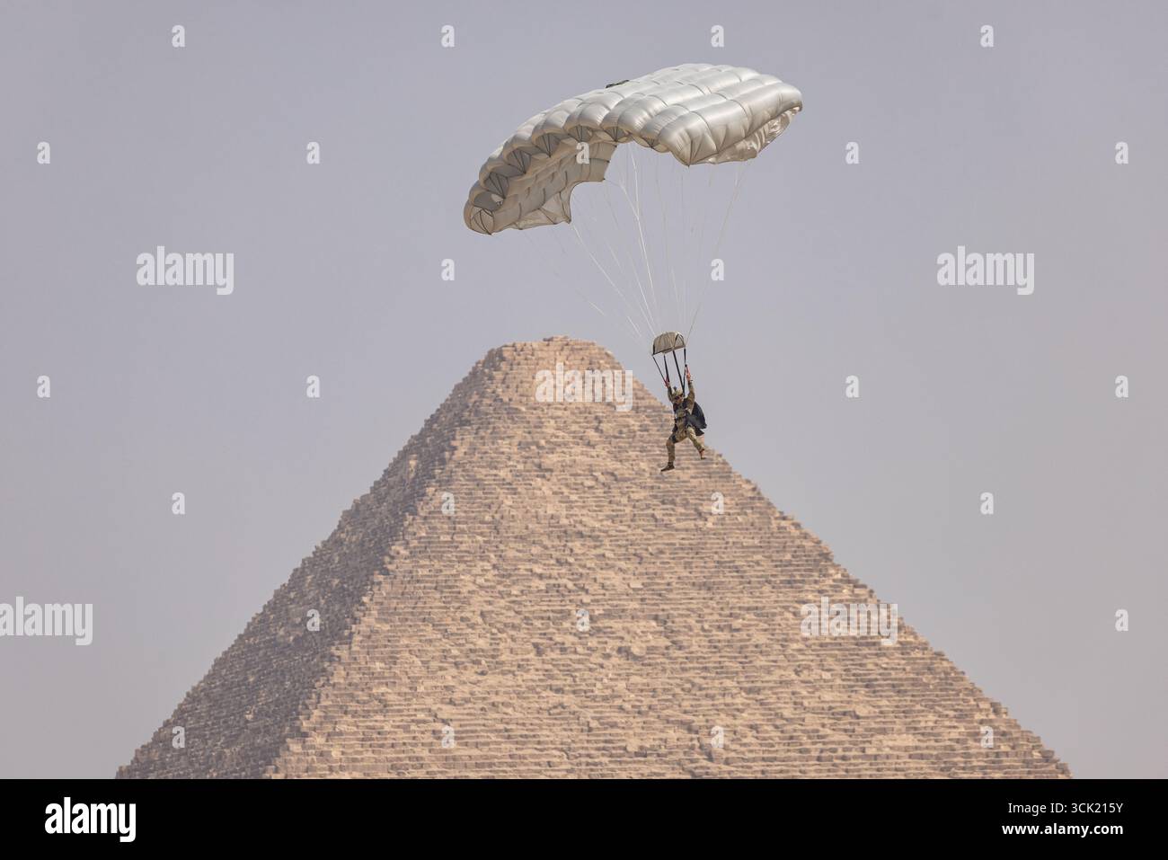 Giza, Egypt. 06 September, 2025. A soldier parachutes near the Great ...