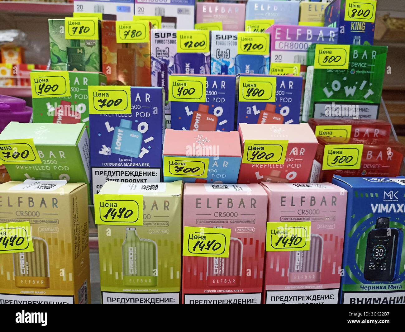 Assorted vape device packaging display with price tags in retail ...