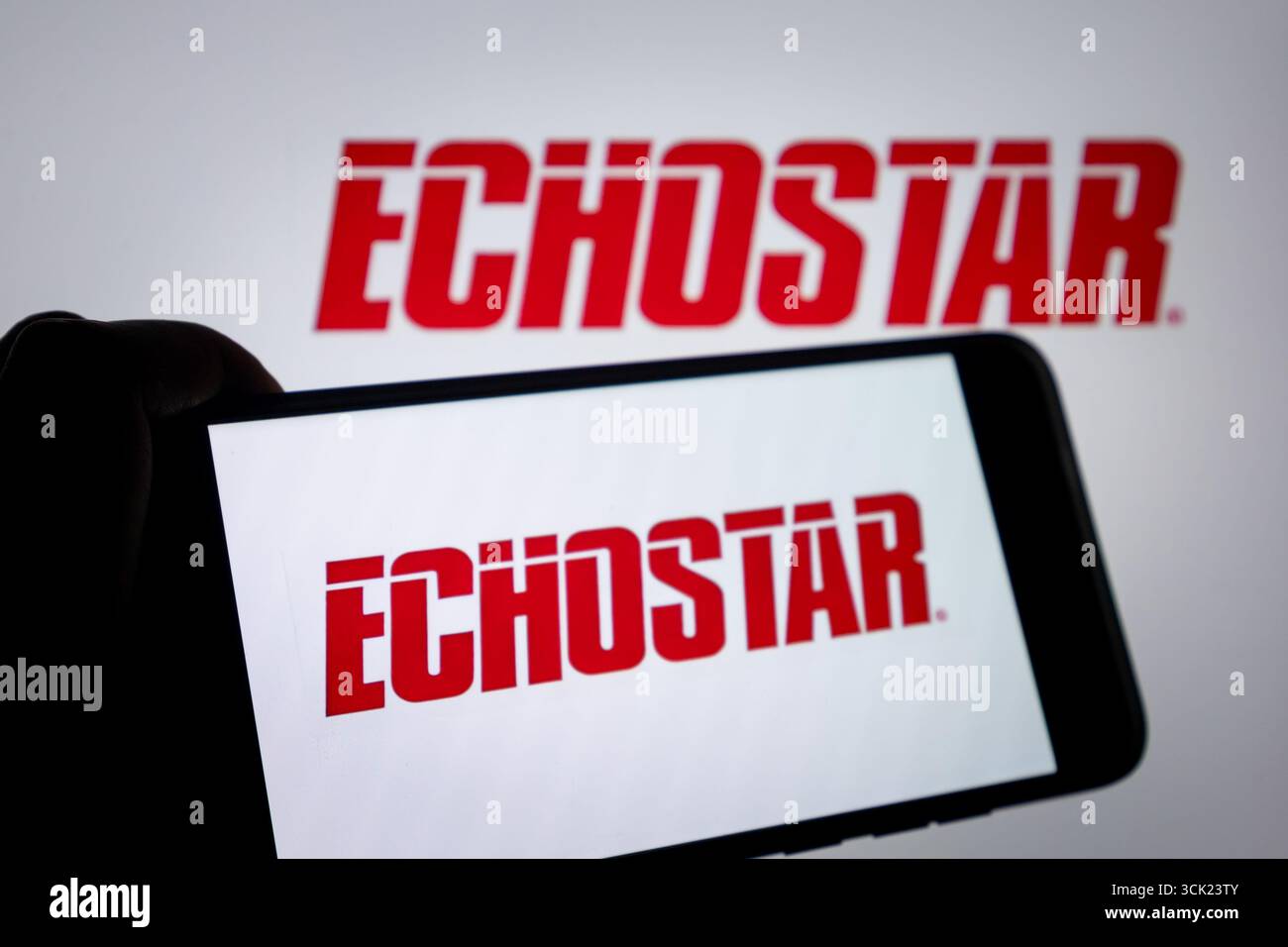 An illustration photo shows EchoStar logo in a smartphone in Chongqing ...