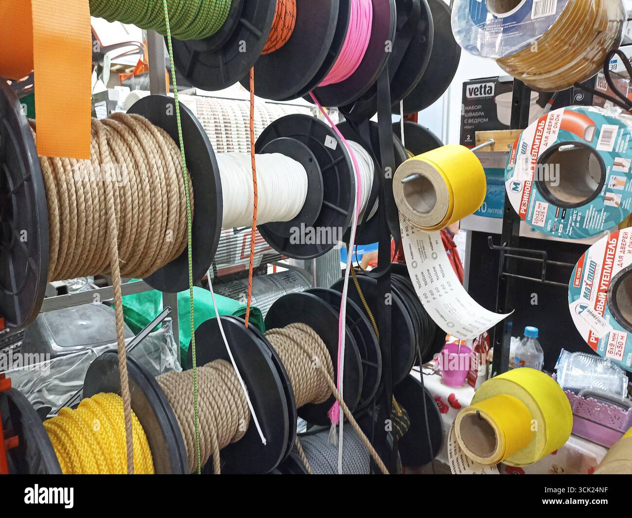 Variety of colored ropes and cables on display in a hardware store ...