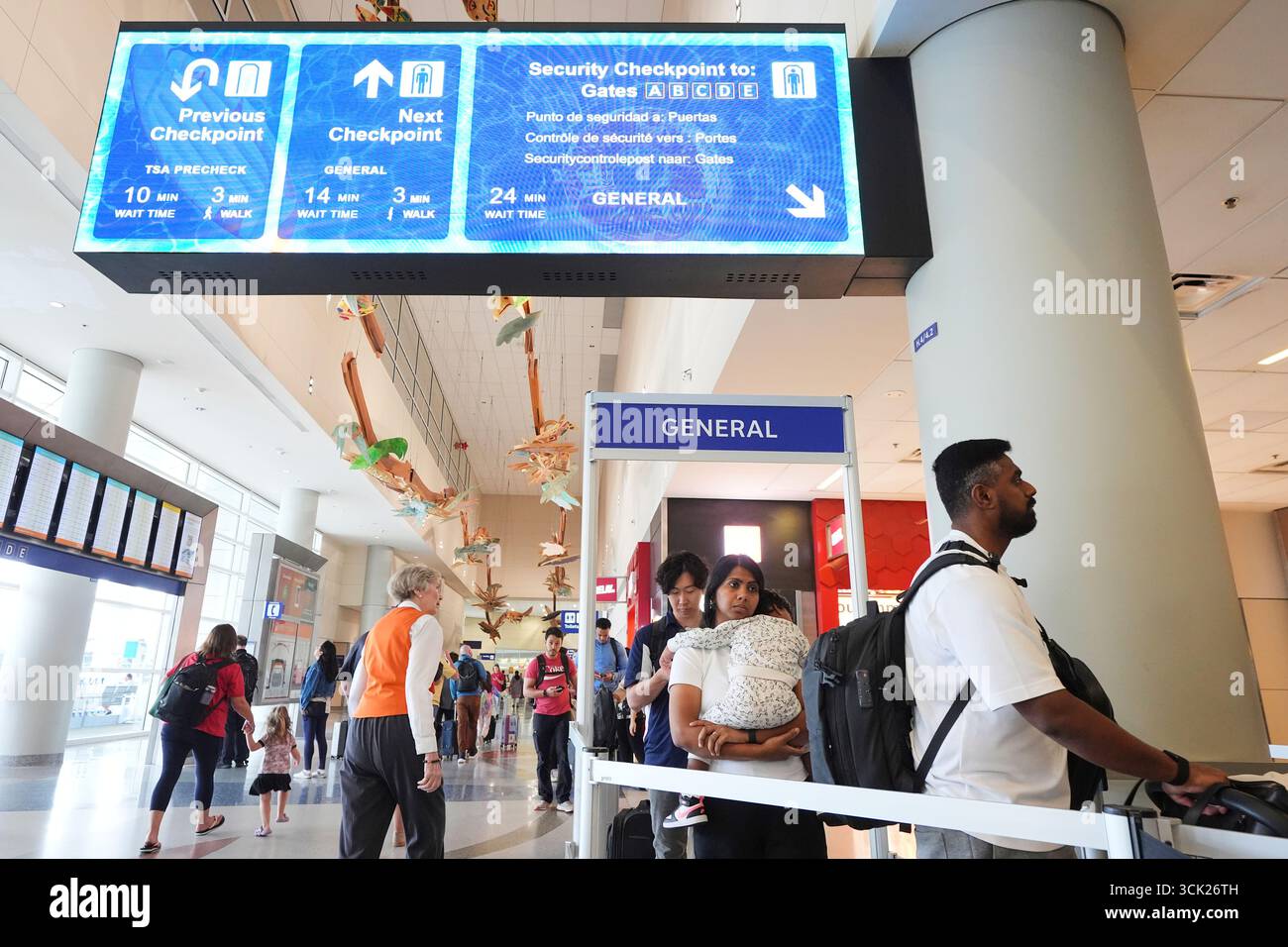 Travelers make their way through a concourse at Dallas Fort Worth ...