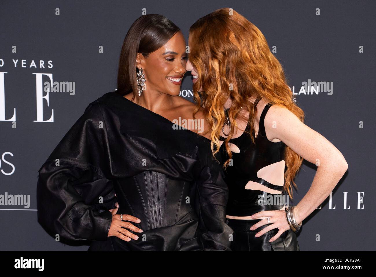 Alex Scott, left, and Jess Glynne pose for photographers upon arrival ...
