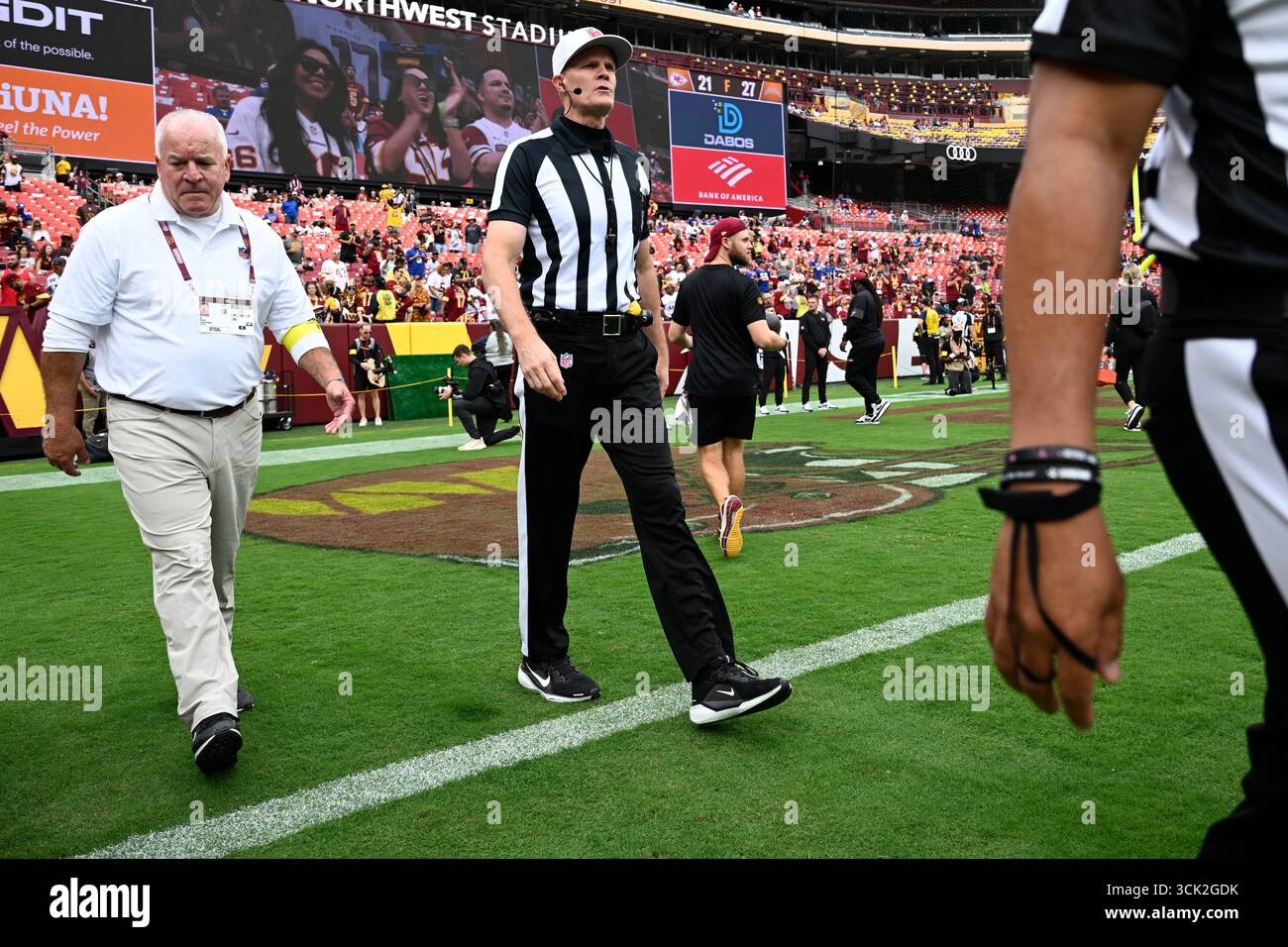 NFL referee Clay Martin, center, before an NFL football game between ...