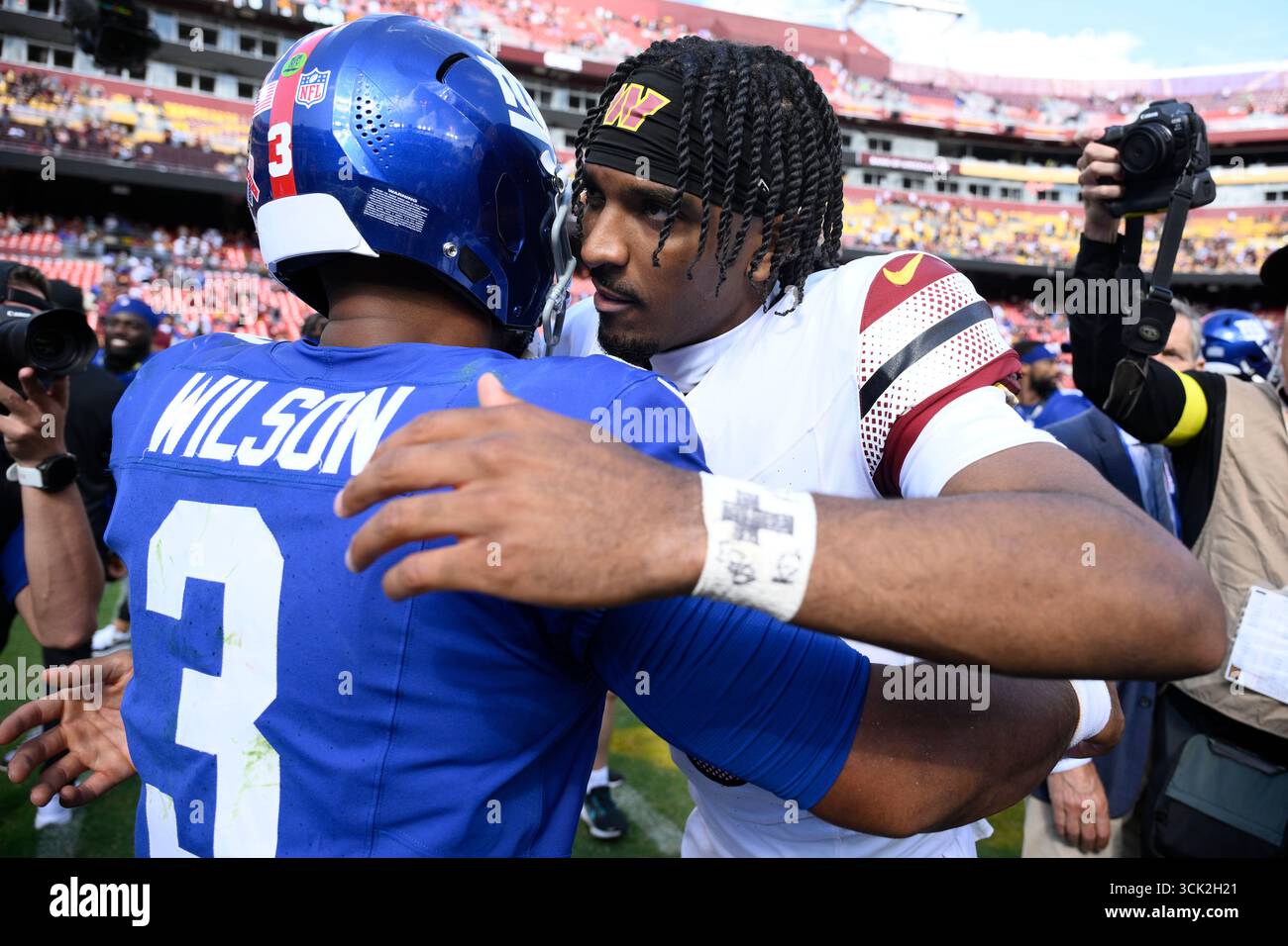 New York Giants quarterback Russell Wilson (3) and Washington Commanders quarterback Jayden ...