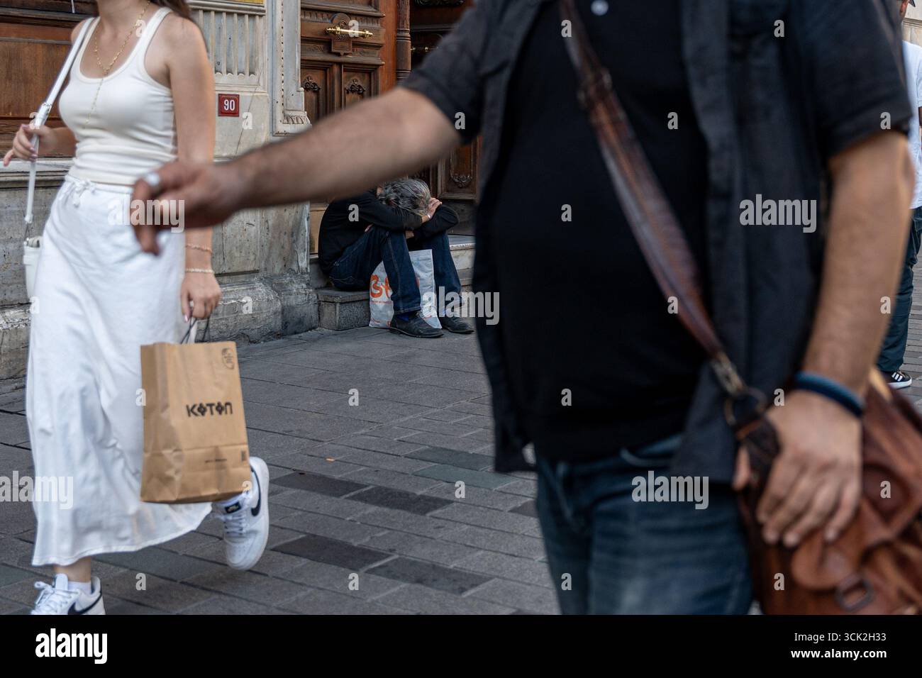 A man sits sadly on Istiklal Street, a tourist spot. (Photo by Tunahan ...