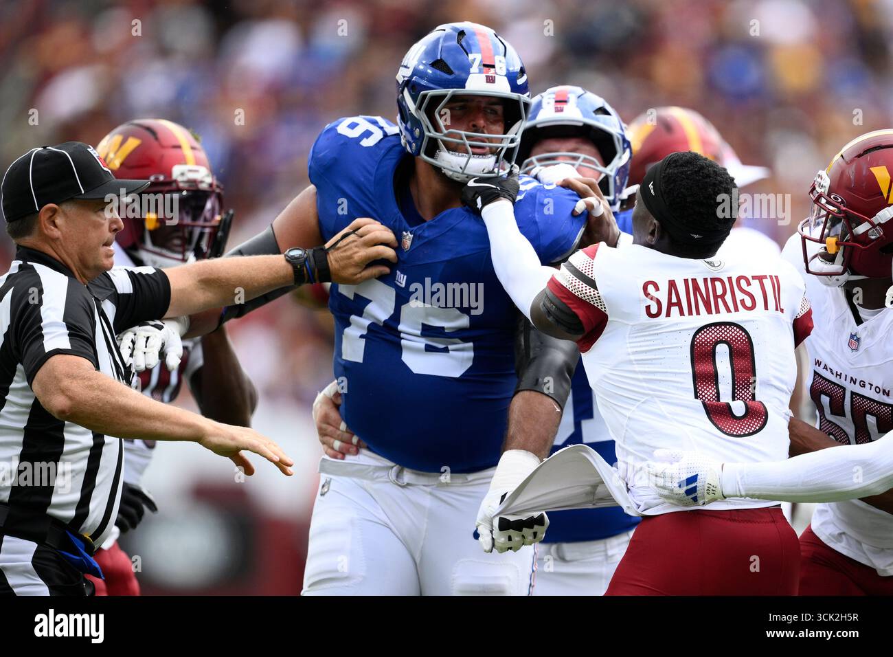Washington Commanders cornerback Mike Sainristil (0) and New York ...