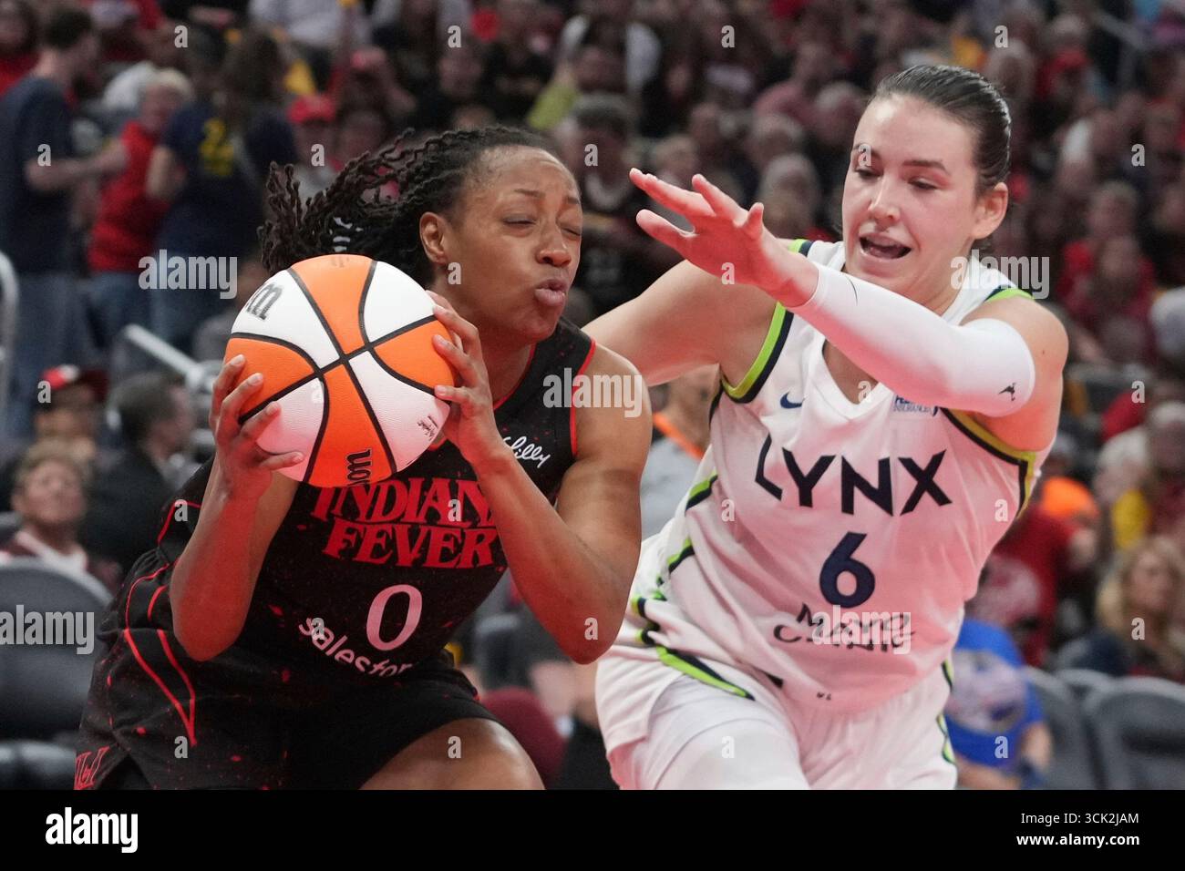 Indiana Fever's Kelsey Mitchell (0) goes to the basket against ...