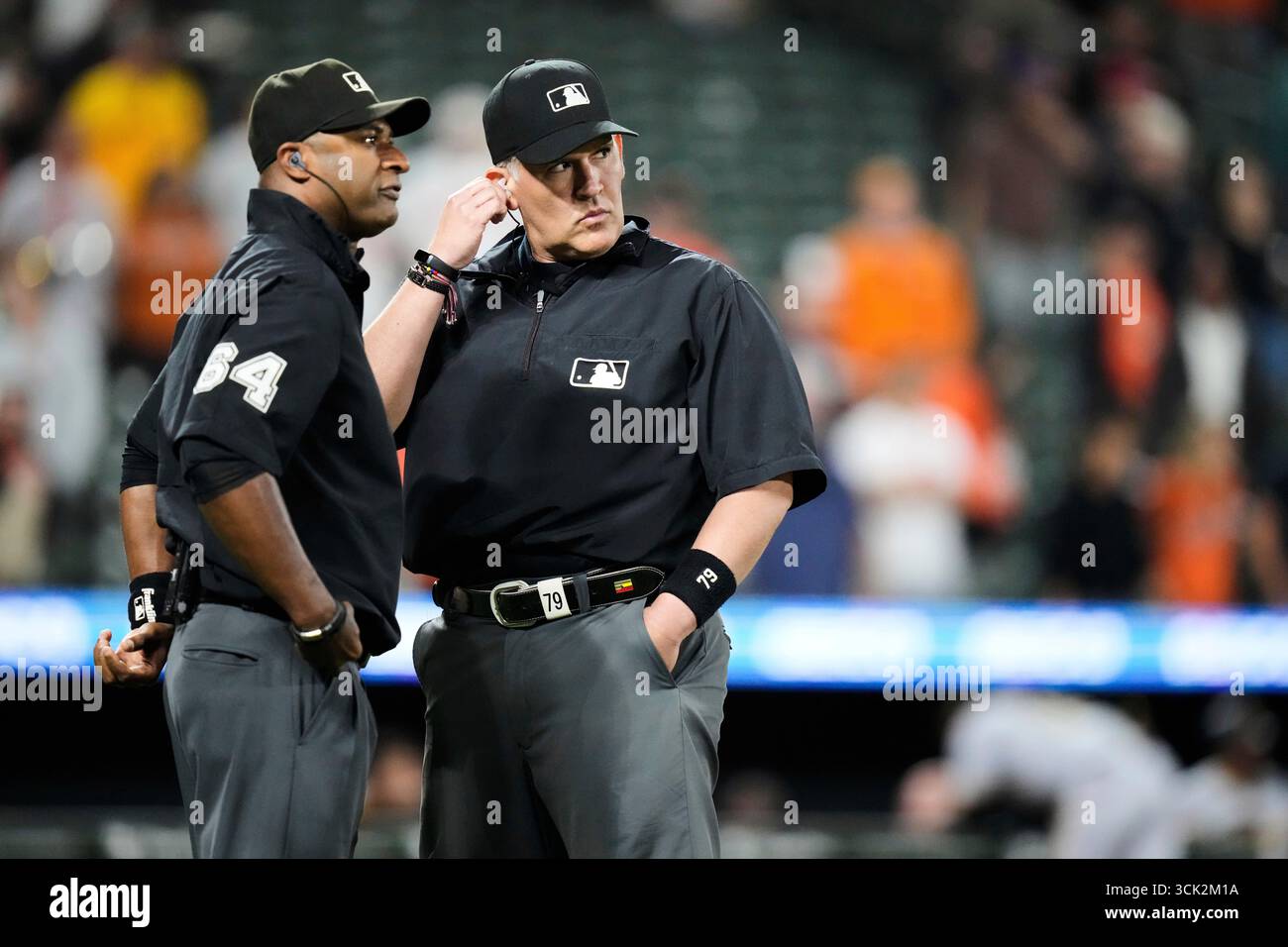 Umpires Alan Porter (64) and Manny Gonzalez wait for a challenge call ...