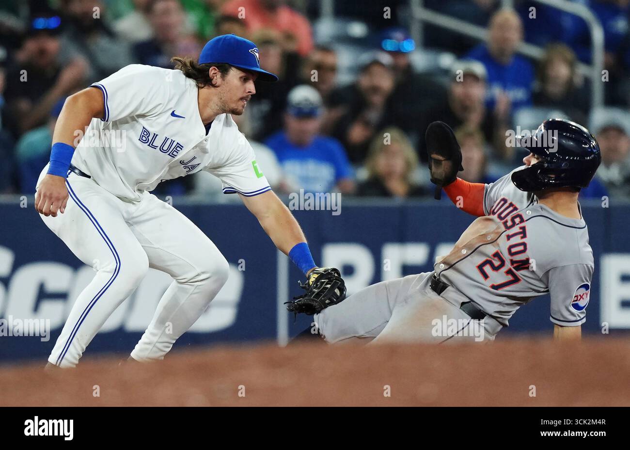 Toronto Blue Jays third baseman Addison Barger (left) tags our Houston ...