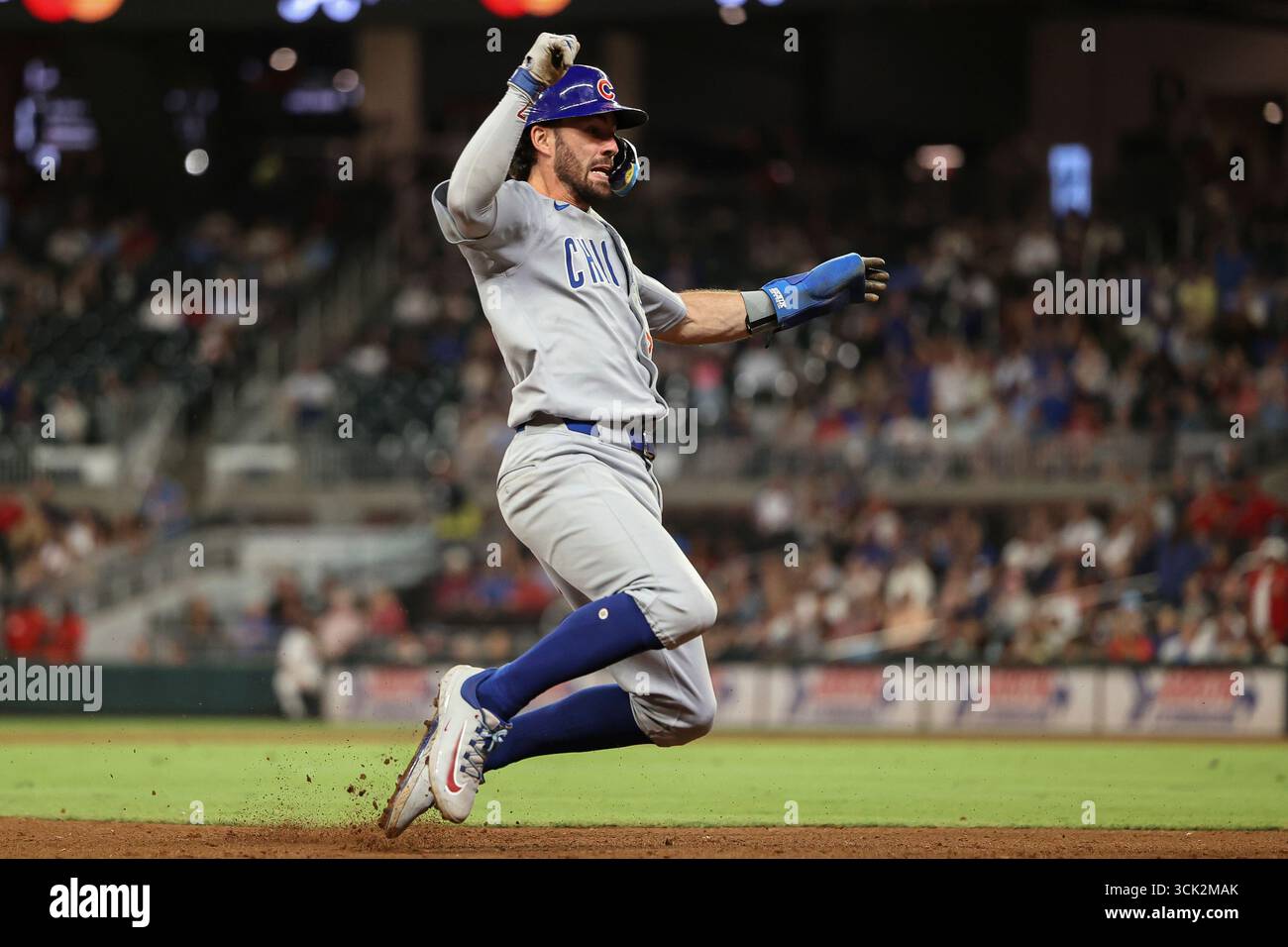 Chicago Cubs' Dansby Swanson starts a slide into third base in the ...