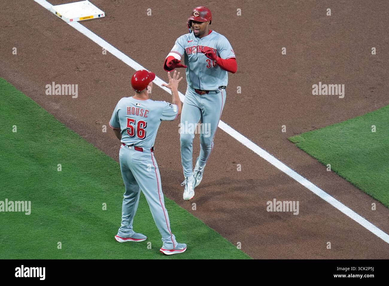 Cincinnati Reds' Will Benson, right, celebrates with third base coach J ...