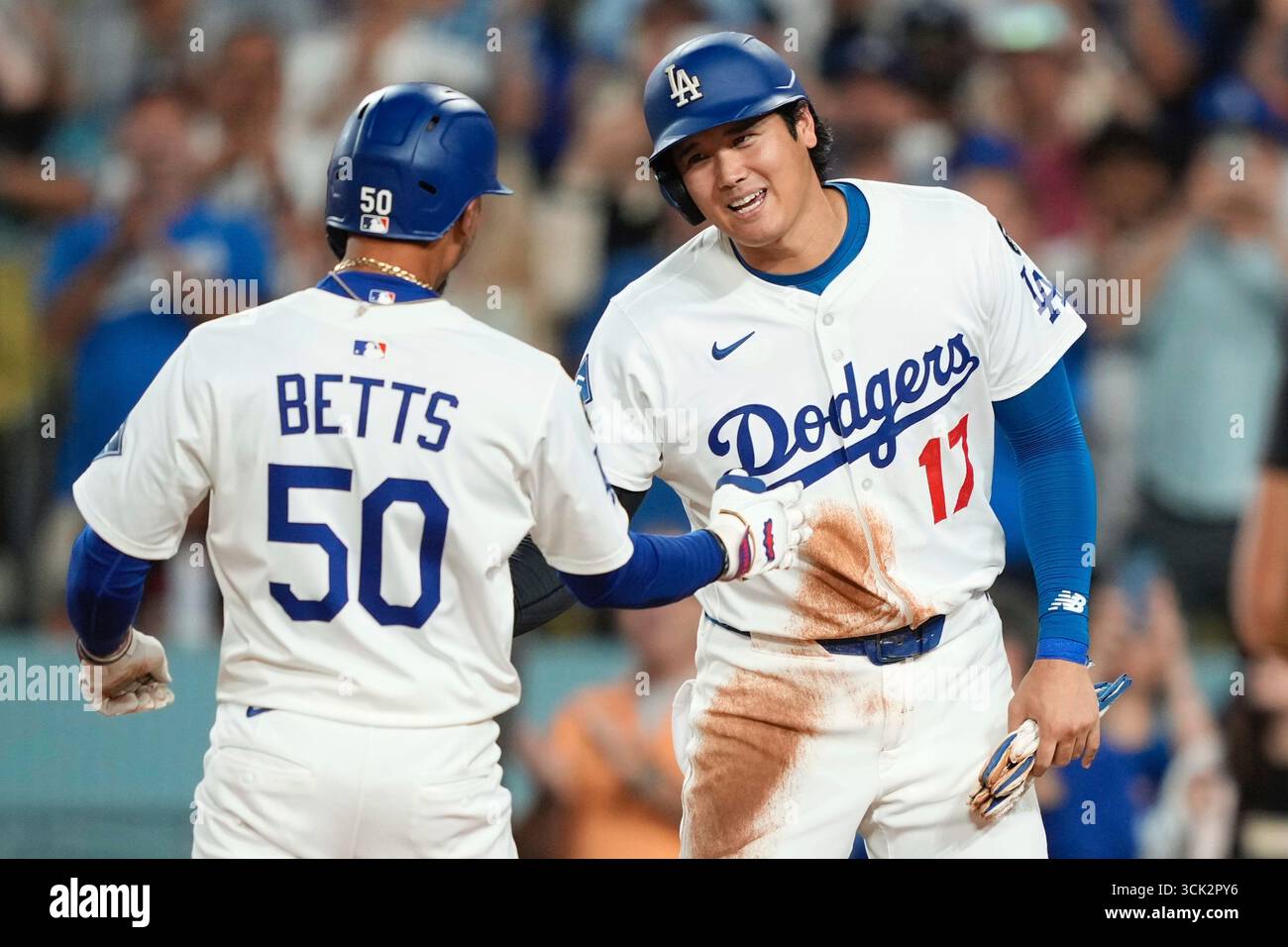 Los Angeles Dodgers' Mookie Betts is congratulated by Shohei Ohtani ...