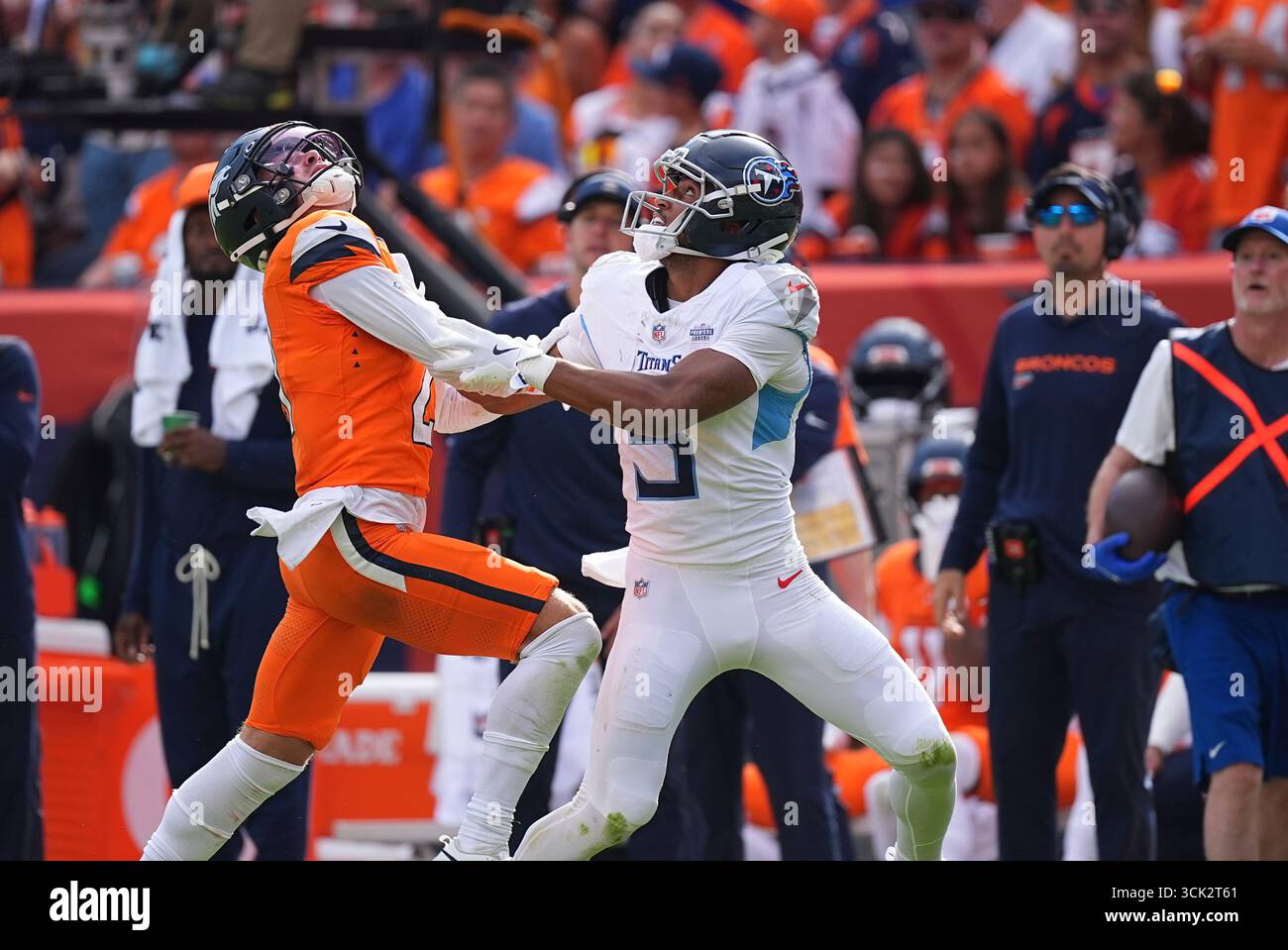 Denver Broncos cornerback Riley Moss (21) and Tennessee Titans wide ...