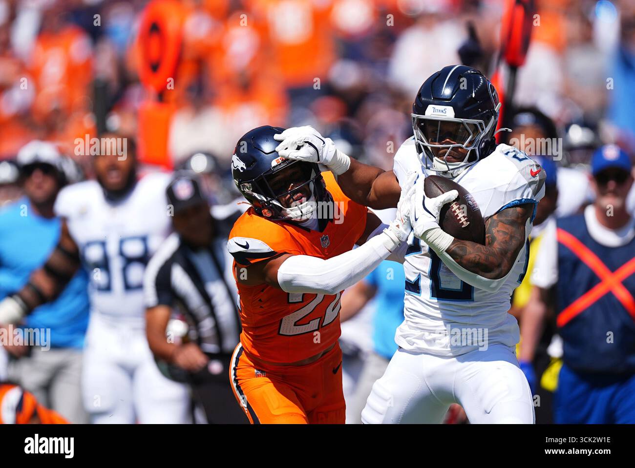 Tennessee Titans running back Tony Pollard (20) fends off Denver ...