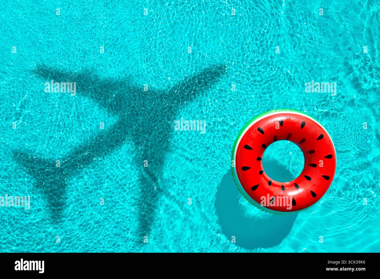 Inflatable ring floating in swimming pool, top view. Flying airplane ...