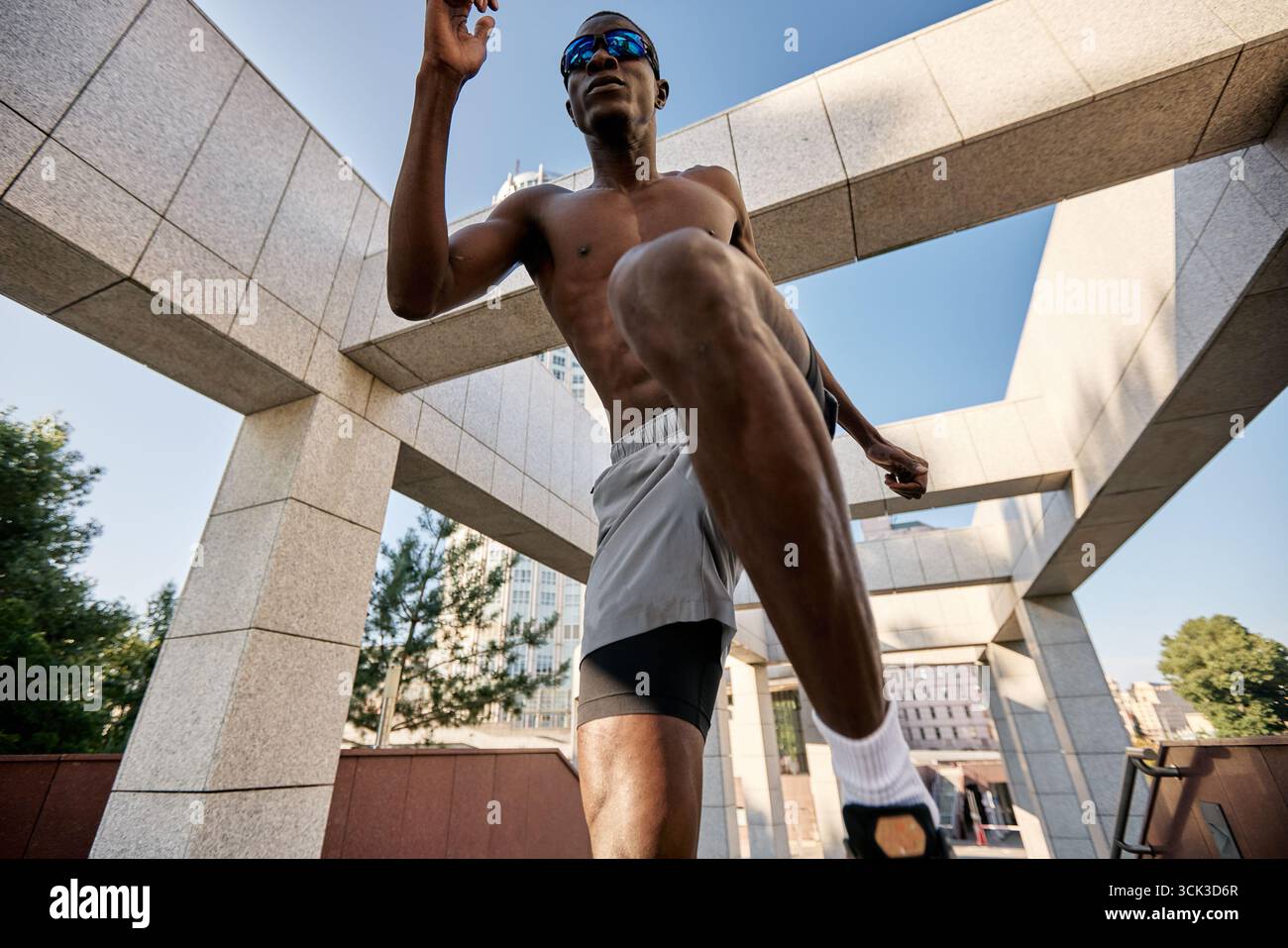 Dynamic image capturing a fit young individual running within a city ...