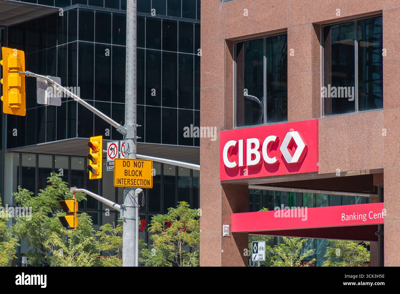 CIBC bank branch on a city street corner with traffic signs, modern ...