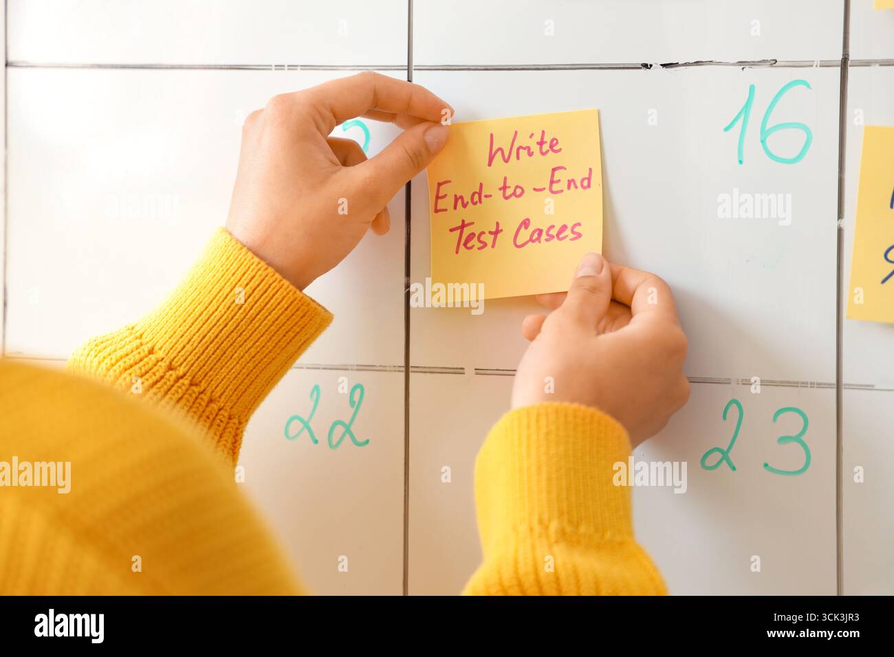 Female hands sticking note with plans on whiteboard in office, closeup ...