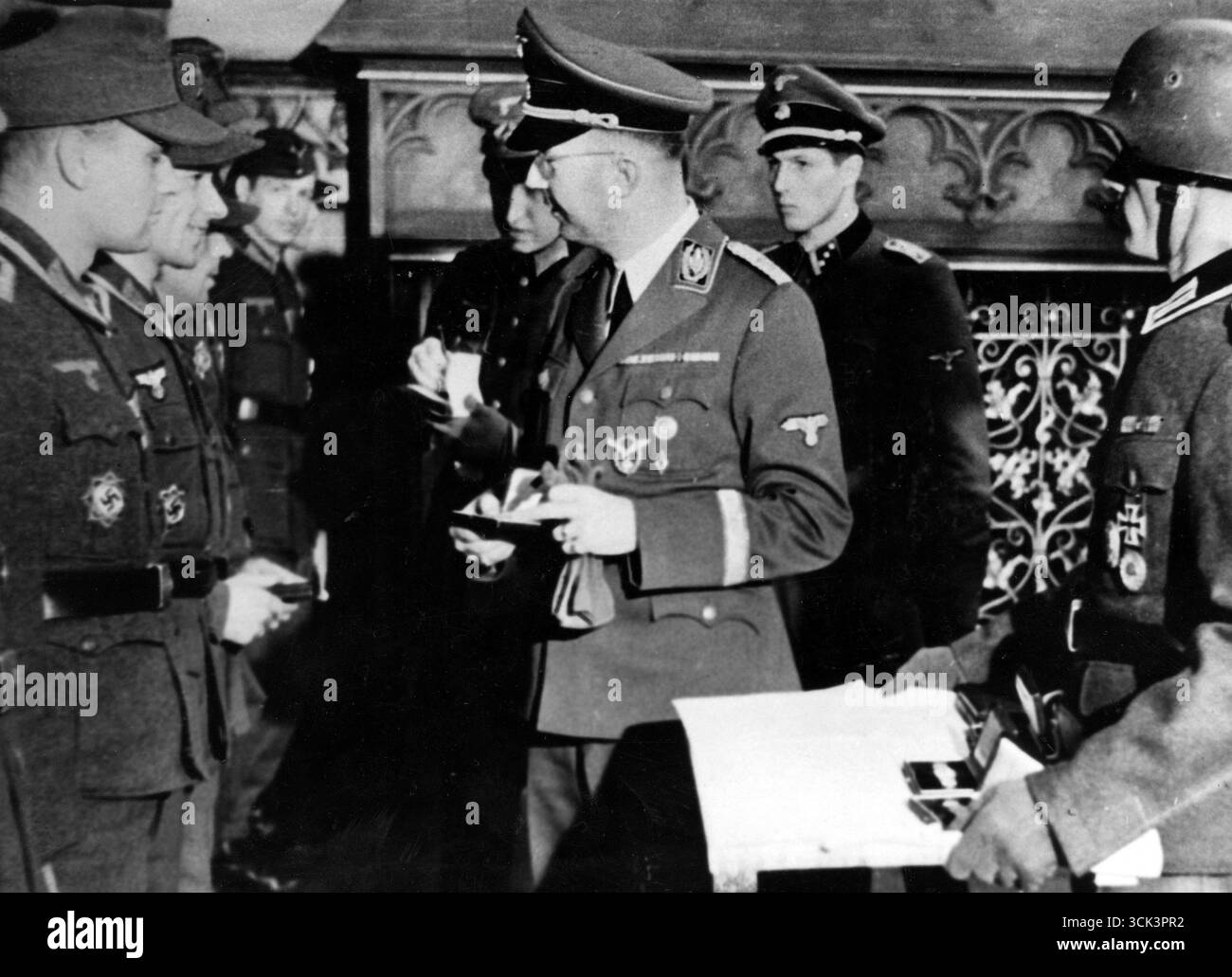 WWII – Reichsfuhrer SS Heinrich Himmler (second from right) presents ...