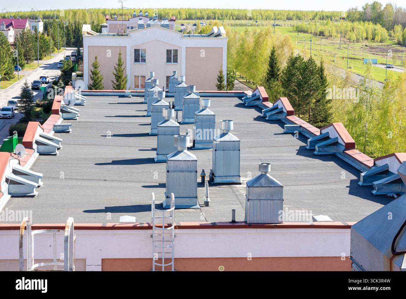 series of metallic ventilation stacks installed on a flat roof for ...