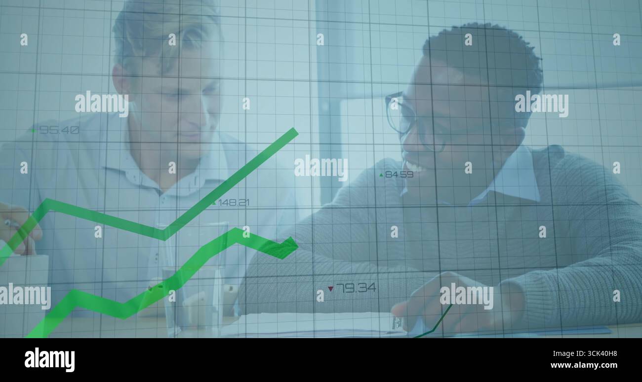 Reviewing professionals analyzing financial printouts at office desk ...