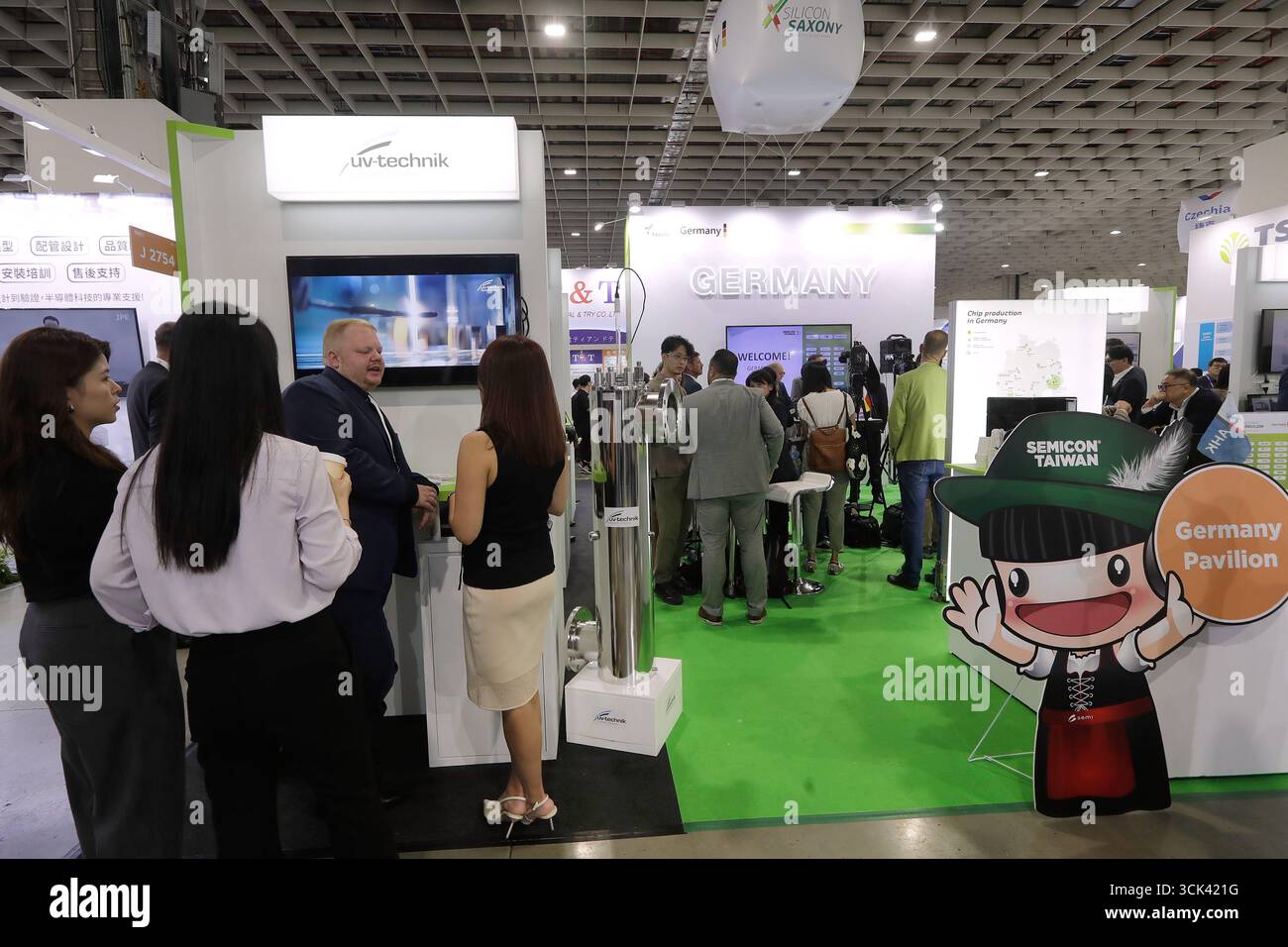 Visitors walk by Germany pavilion booth during the SEMICON Taiwan ...