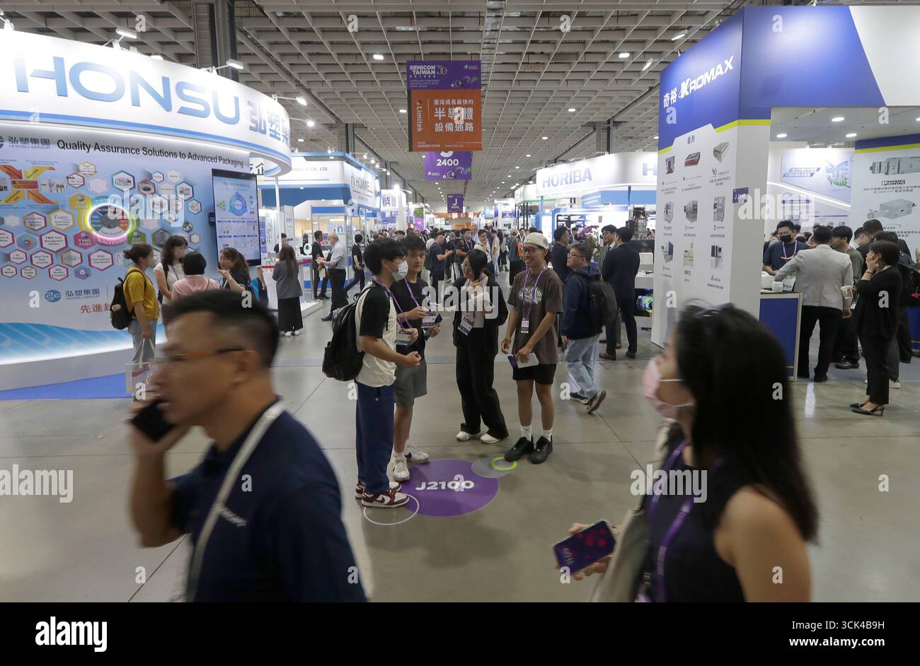 Visitors review new Semicon products during the SEMICON Taiwan ...