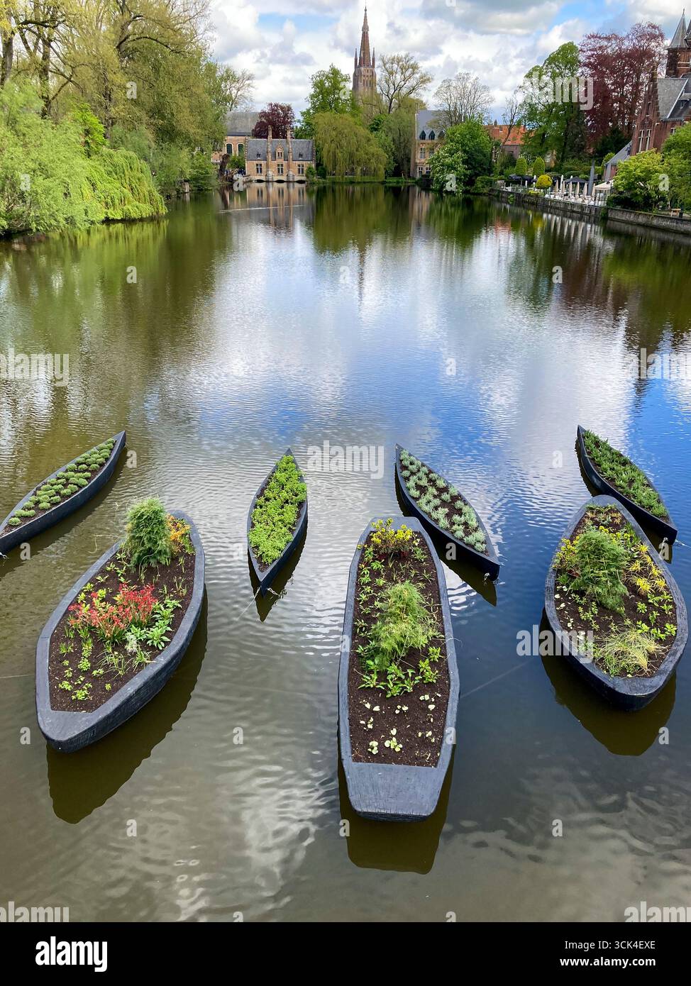 Canoes used as planters floating on canal Stock Photo - Alamy