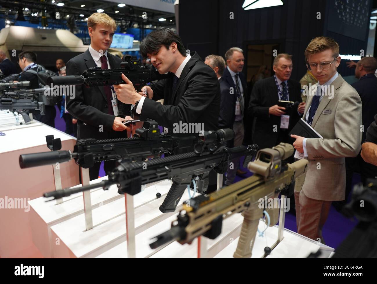People looking at some of the weapons on display at the Defence and ...
