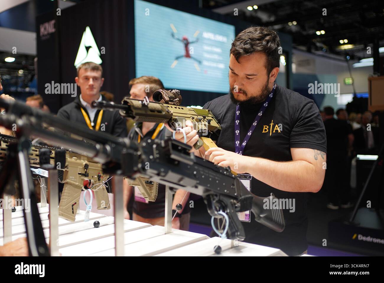People looking at some of the weapons on display at the Defence and ...