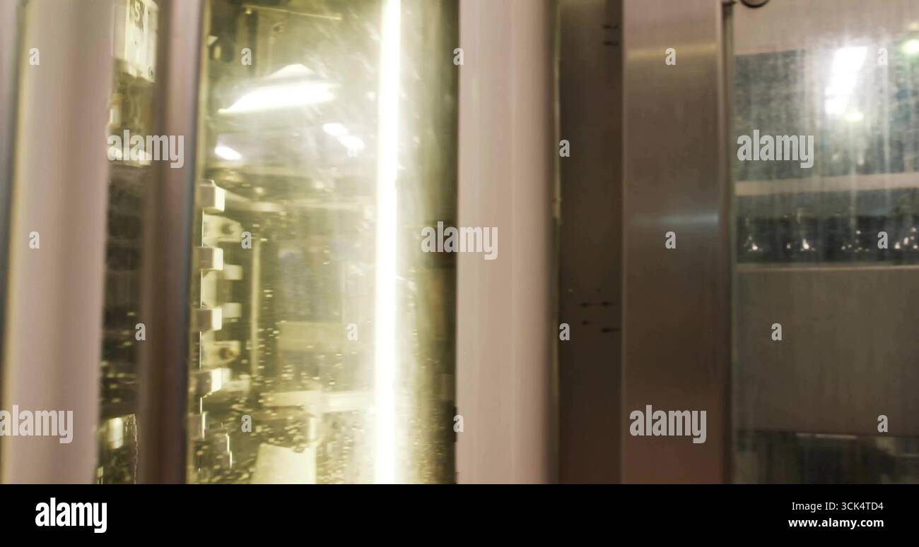 Showing chamber in enclosure with droplet-covered glass panel, bars ...