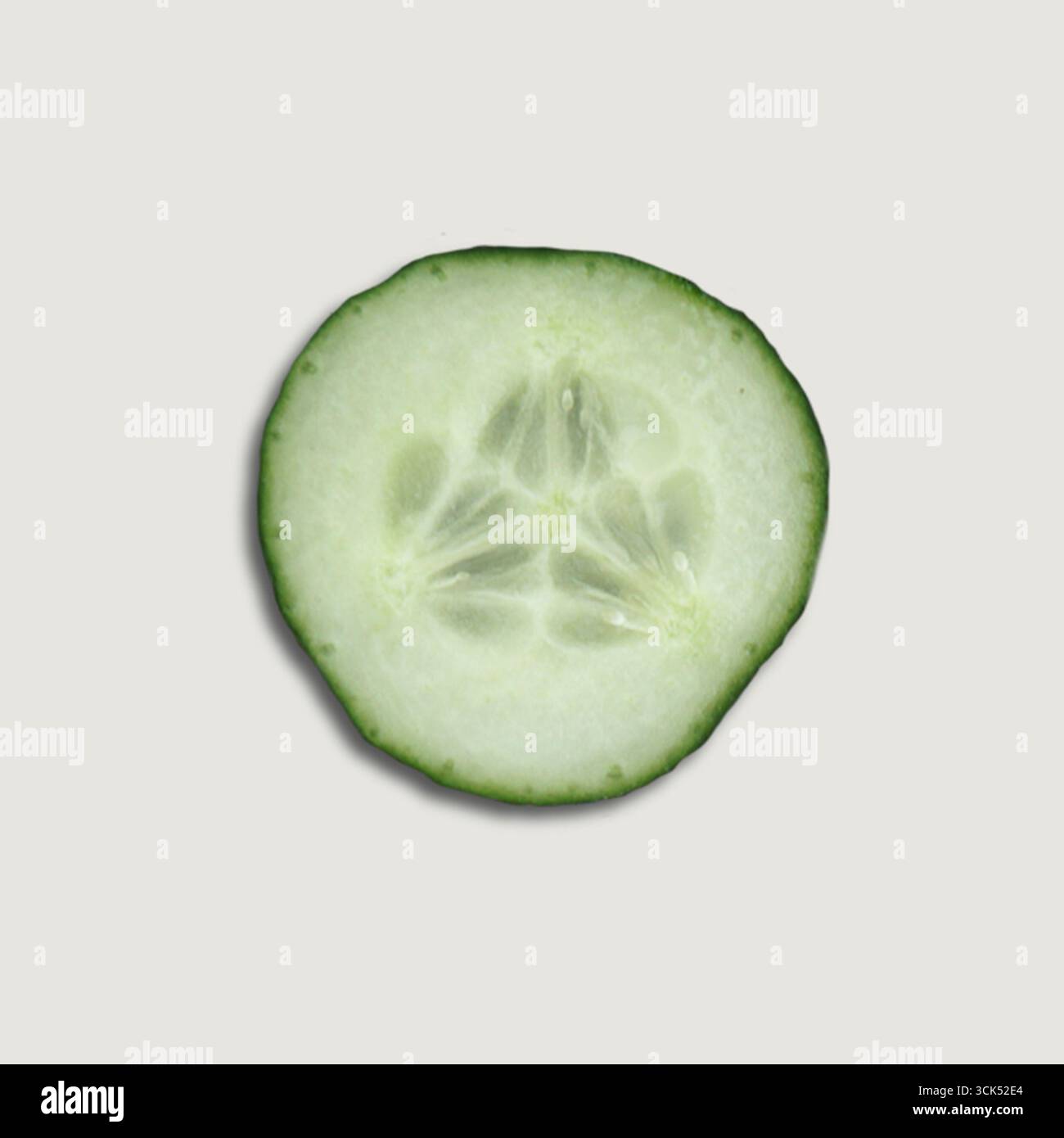 A cross-section of a cucumber showcasing its green skin and seeds Stock ...