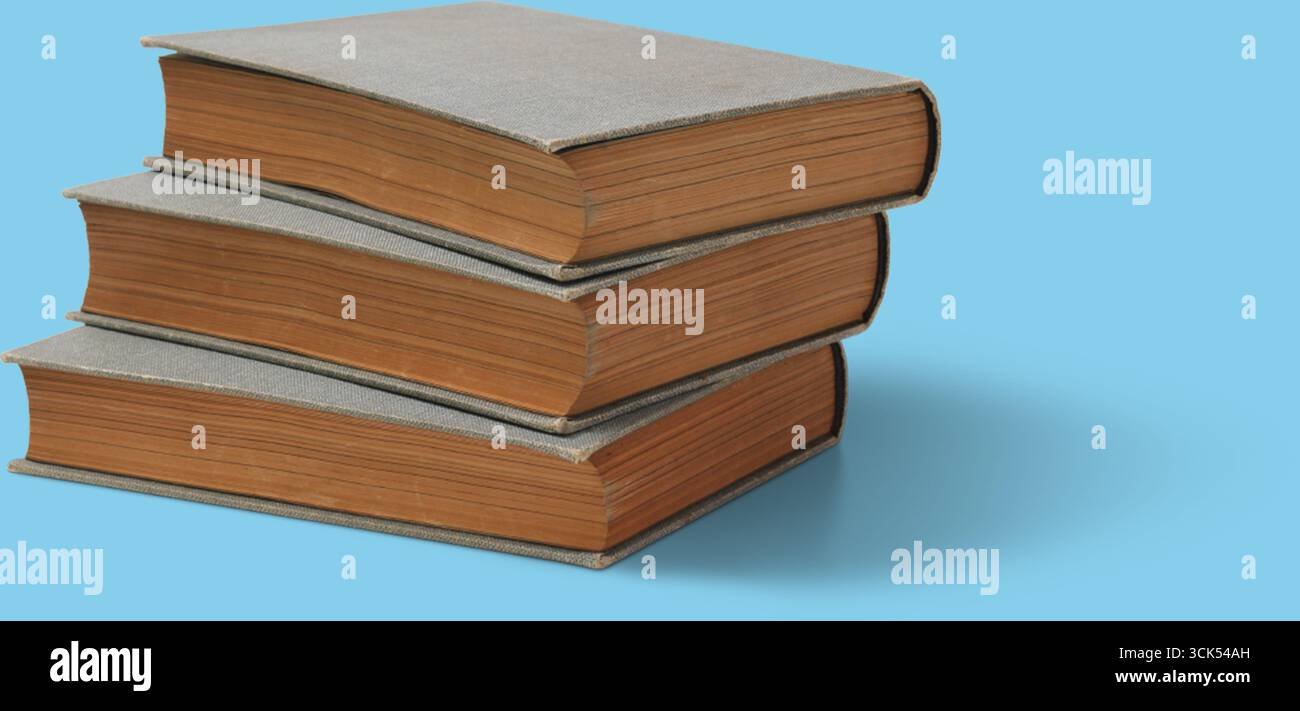 A stack of three thick books with textured covers, suggesting knowledge ...