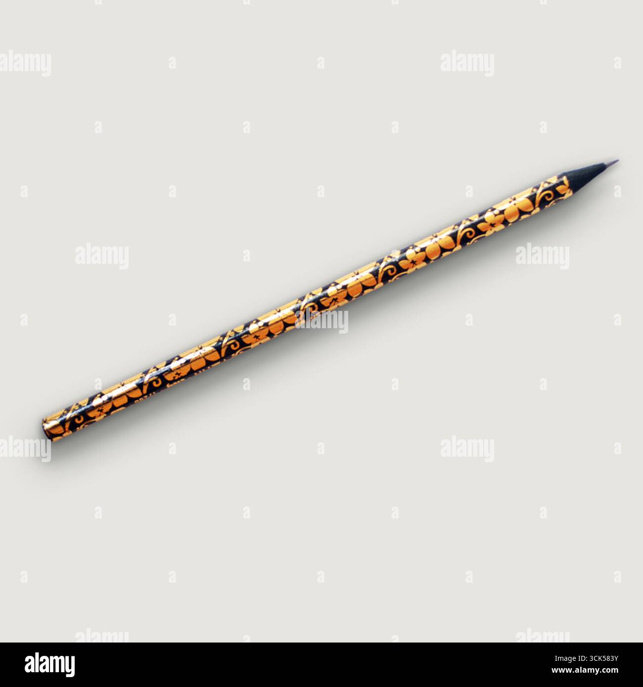 A decorative black pencil with an intricate orange pattern, designed ...