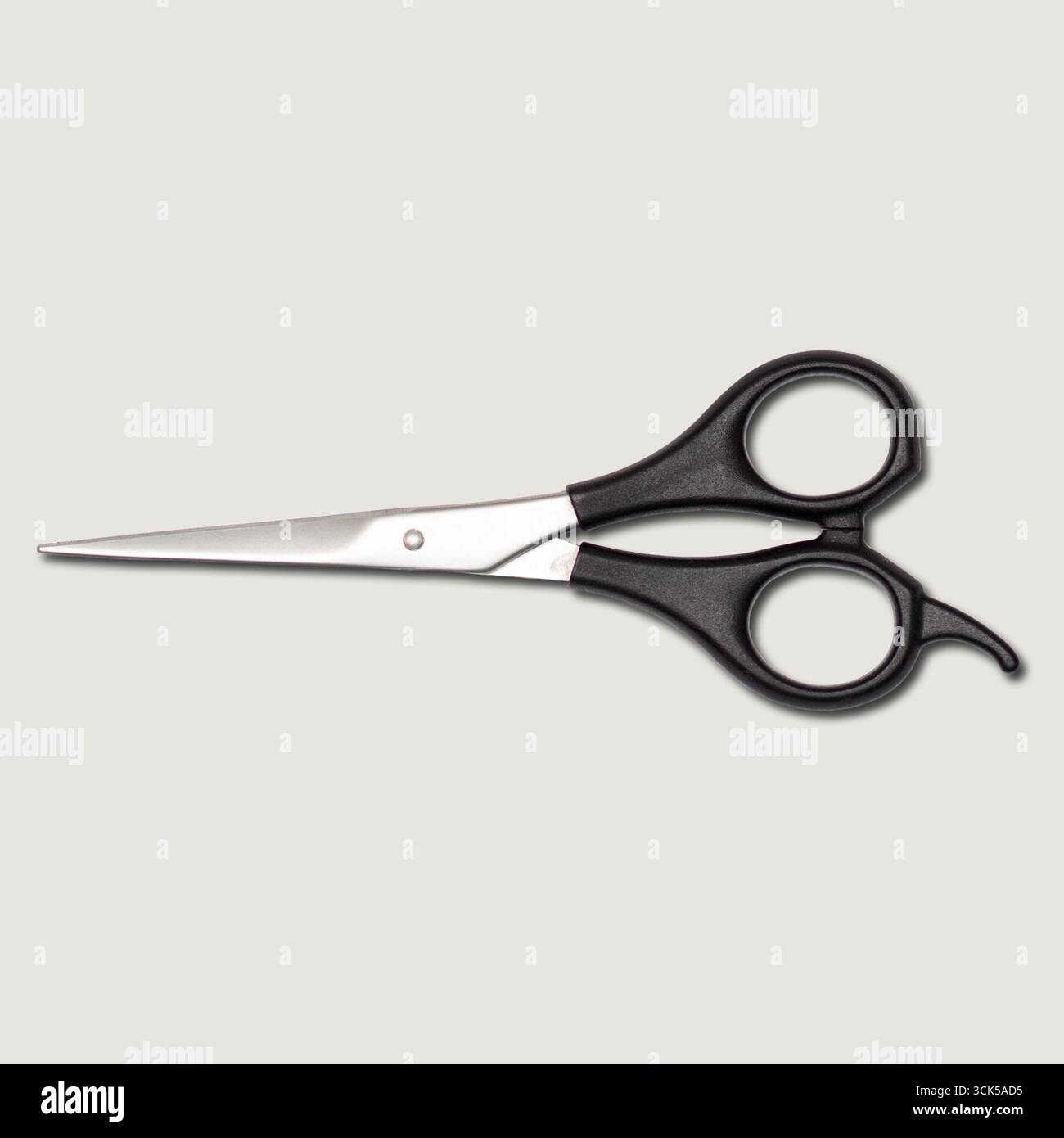 A pair of black-handled scissors designed for cutting various materials ...