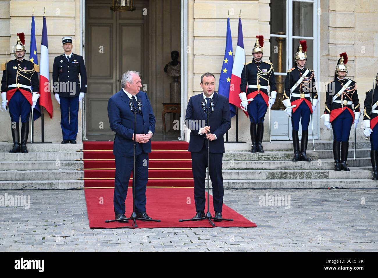French outgoing Prime Minister Francois Bayrou and newly appointed ...
