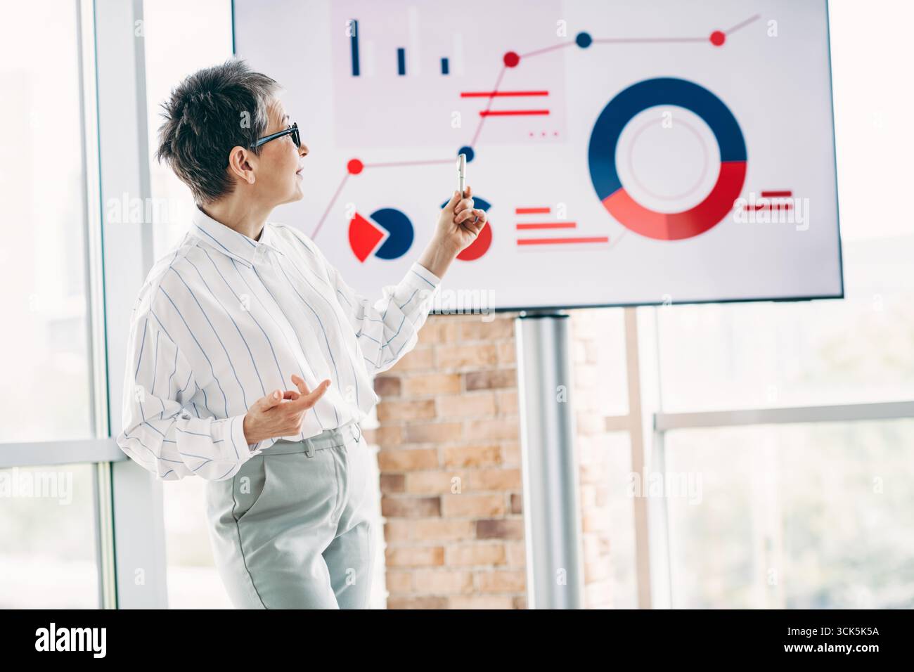 Professional businesswoman presenting analytics in a modern office ...