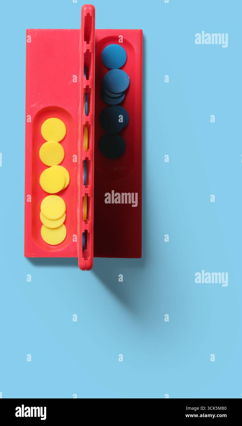 A red game board with yellow and blue tokens arranged in a vertical ...