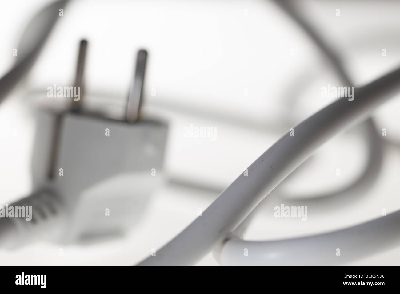 White power plug, Schuko plug with tangled power cable, arrangement ...