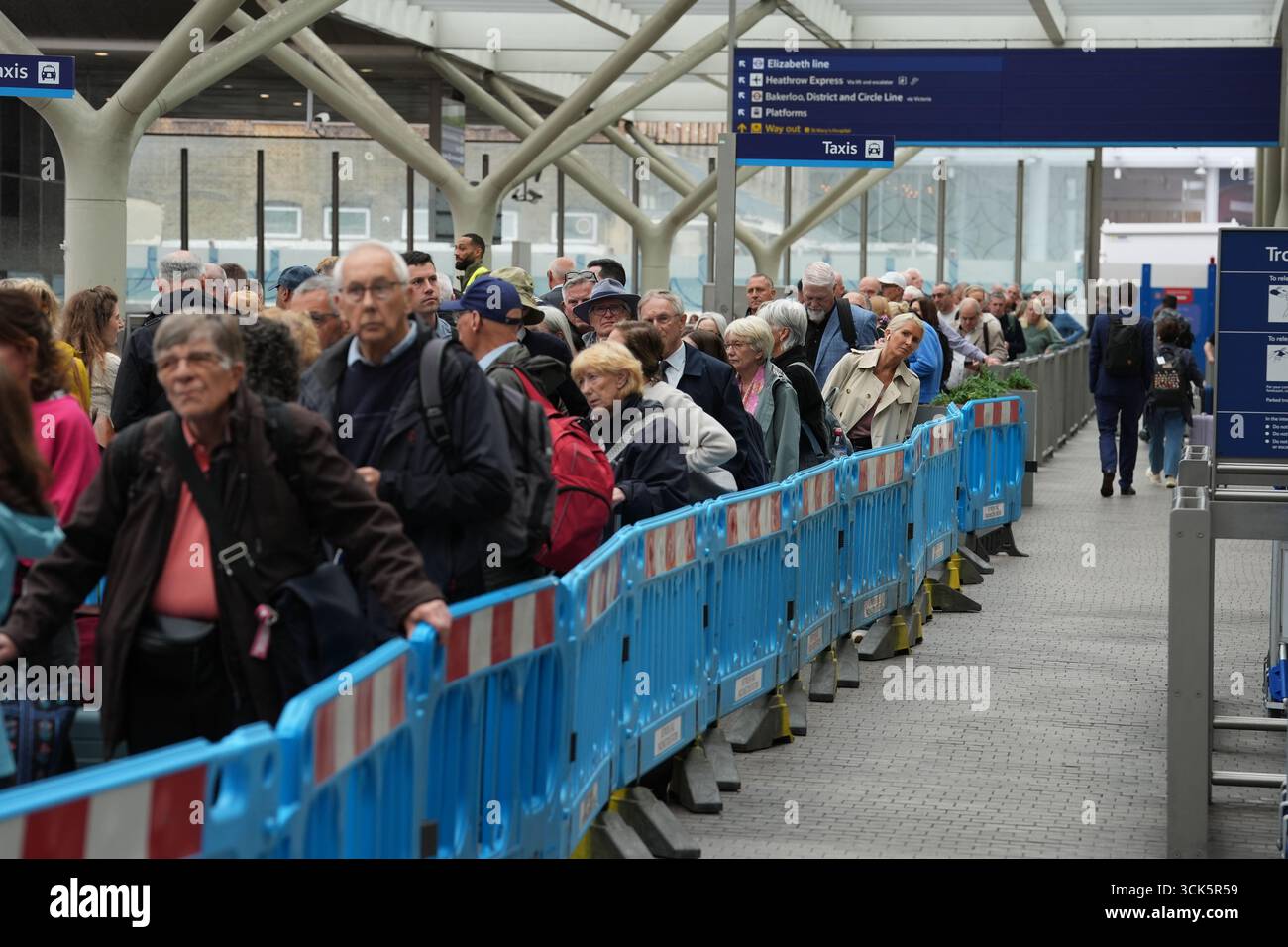 People queue for taxis outside Paddington Station, London, on the third ...