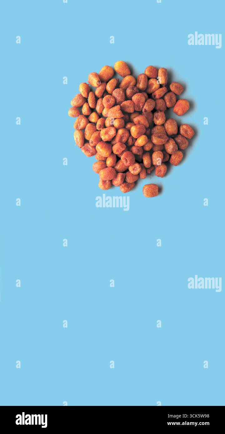 A pile of hazelnuts displayed on a white background, showcasing their ...