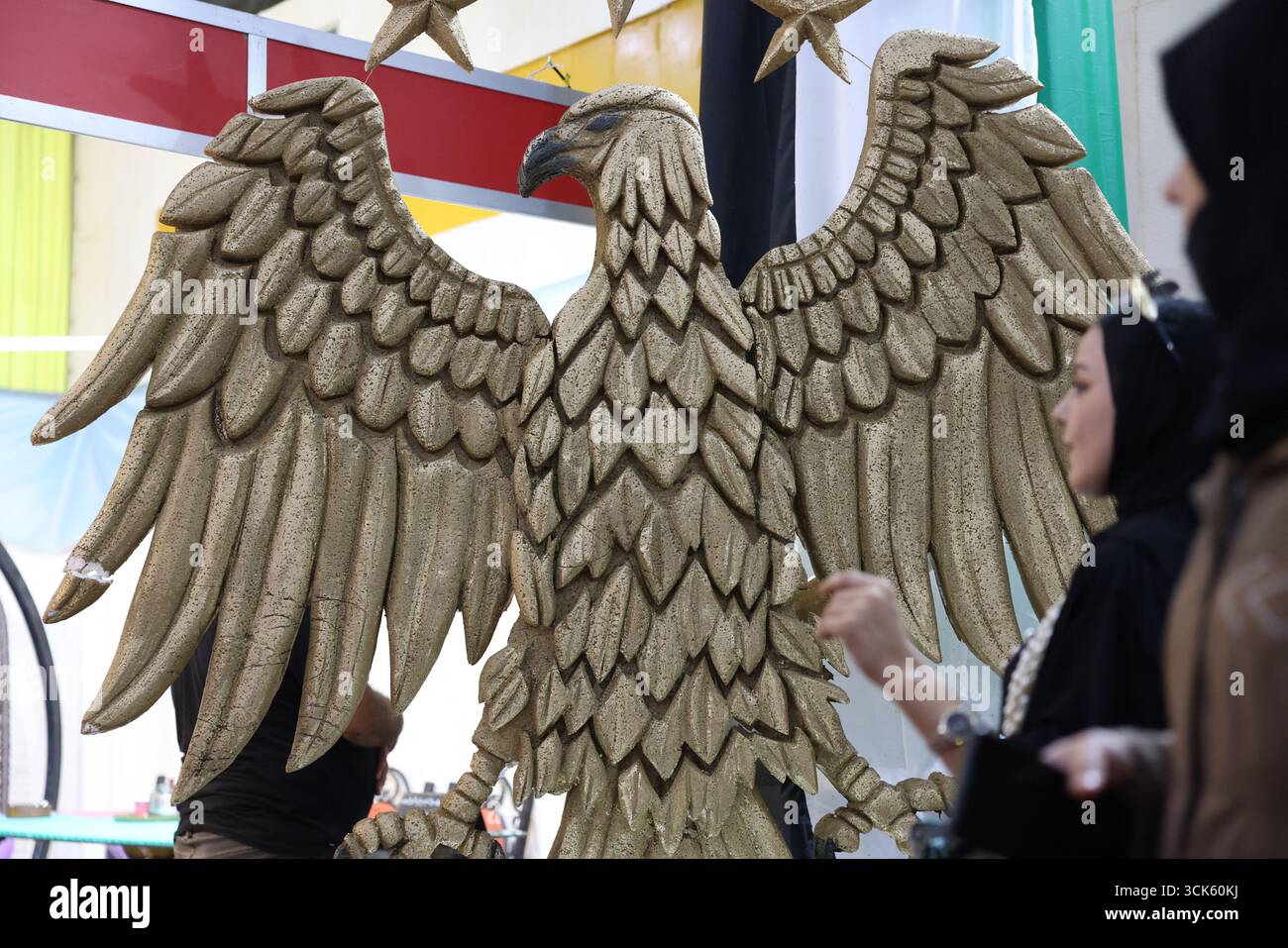 A large sculpture of Syria’s national emblem eagle is displayed inside ...