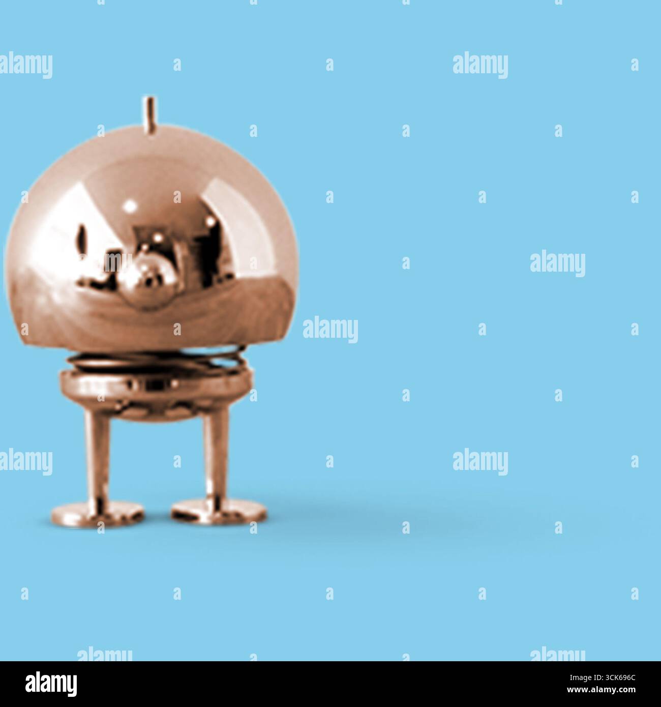 A shiny, metallic bell-shaped object with a rounded top and two legs ...
