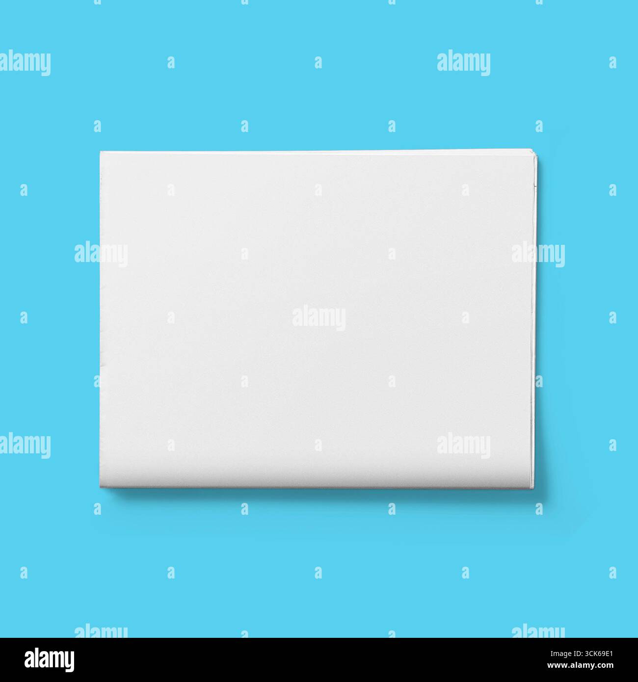 A plain white rectangular object, possibly a notebook or a folder, with ...