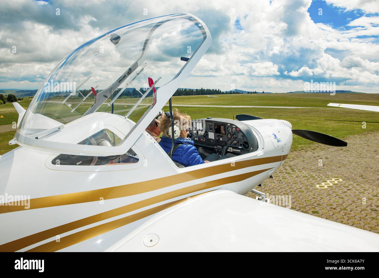 Pilot and passenger co-pilot preparing for take-off in cockpit of two ...