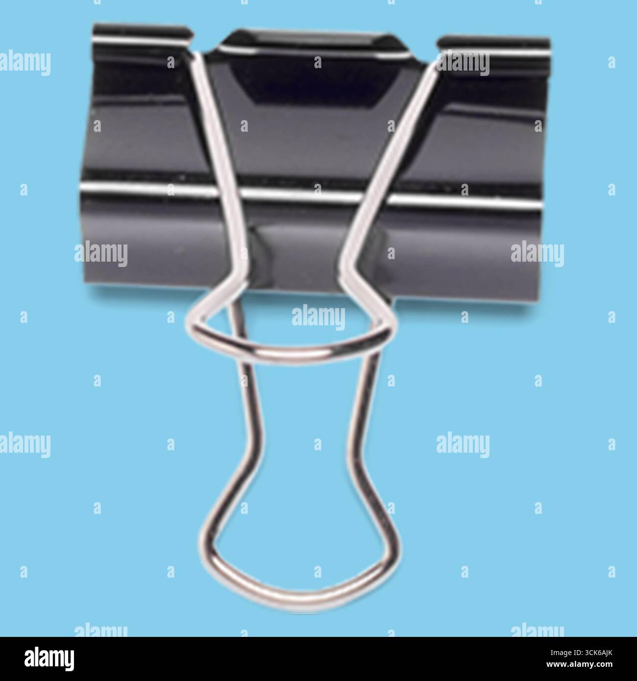 A black binder clip used for holding papers together securely Stock ...