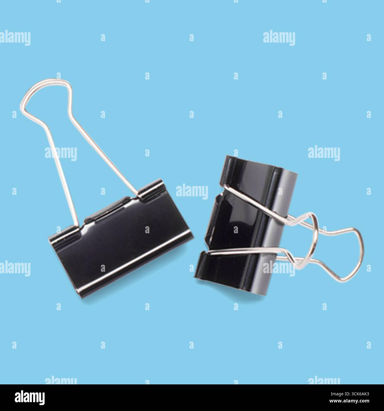 Two black binder clips used for holding papers together securely Stock ...