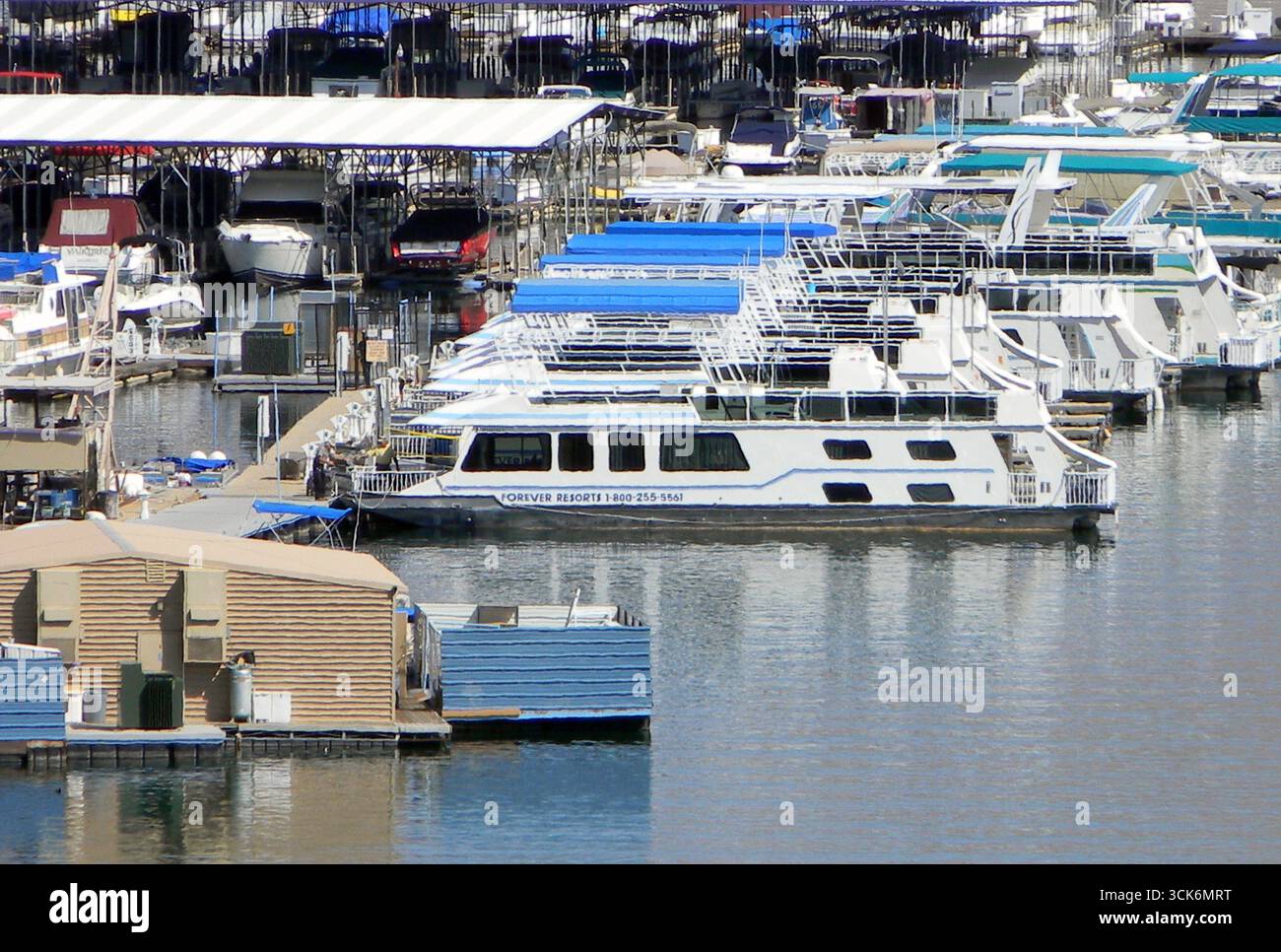 Numerous docked boats arranged in rows at Lake Mead Marina, near ...