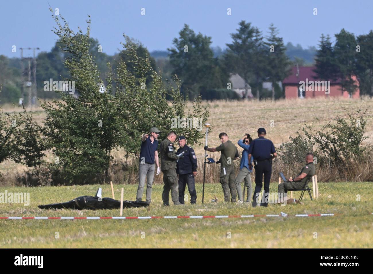 Police and Military Police secure parts of a damaged UAV shot down by ...